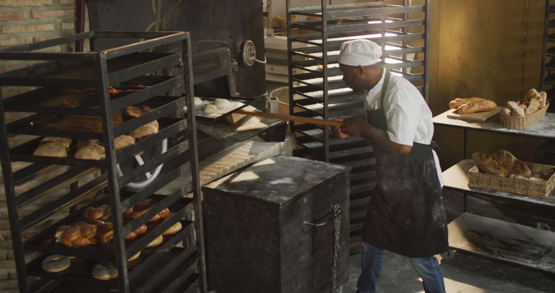 African American Baker Operating Traditional Bread Furnace