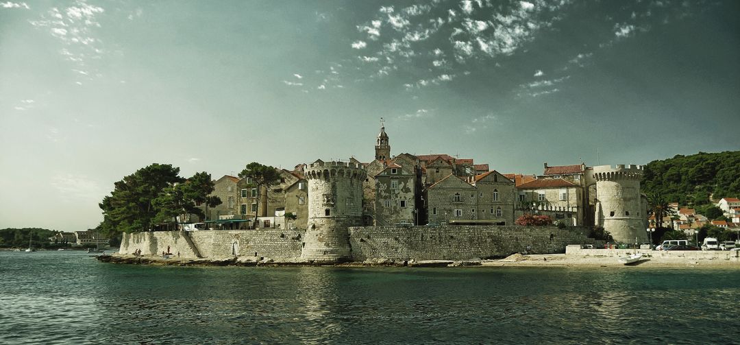 Medieval Coastal Town with Fortified Walls and Historic Architecture
