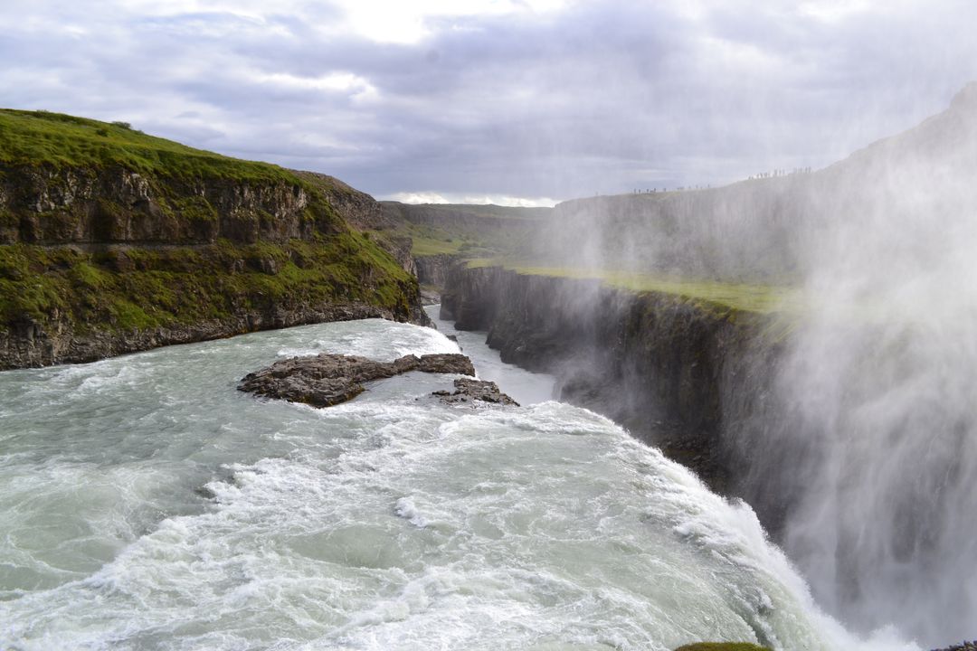 Mighty Waterfall Surrounded by Rugged Landscape with Flowing River